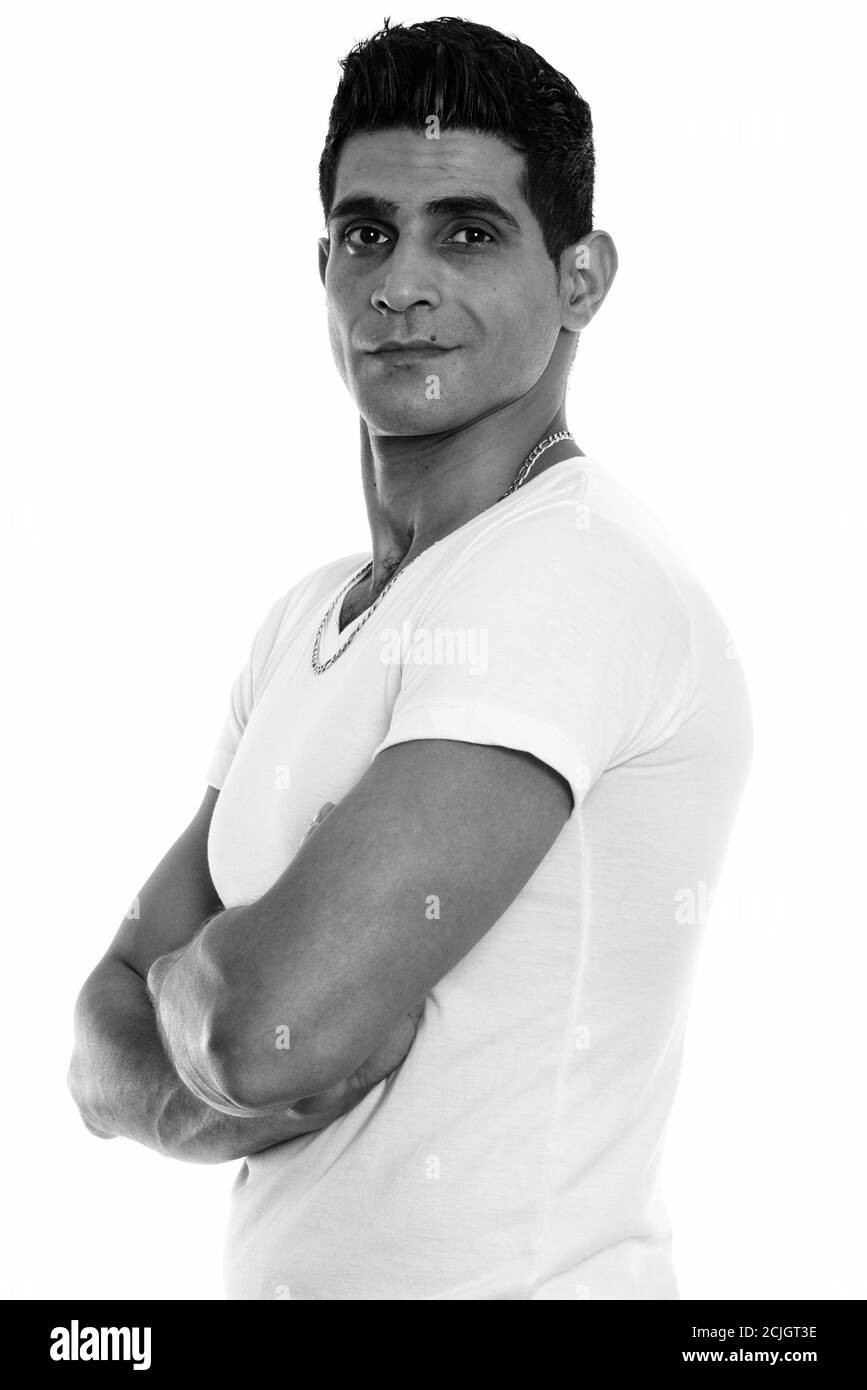 Studio shot of young muscular Persian man with arms crossed Stock Photo ...