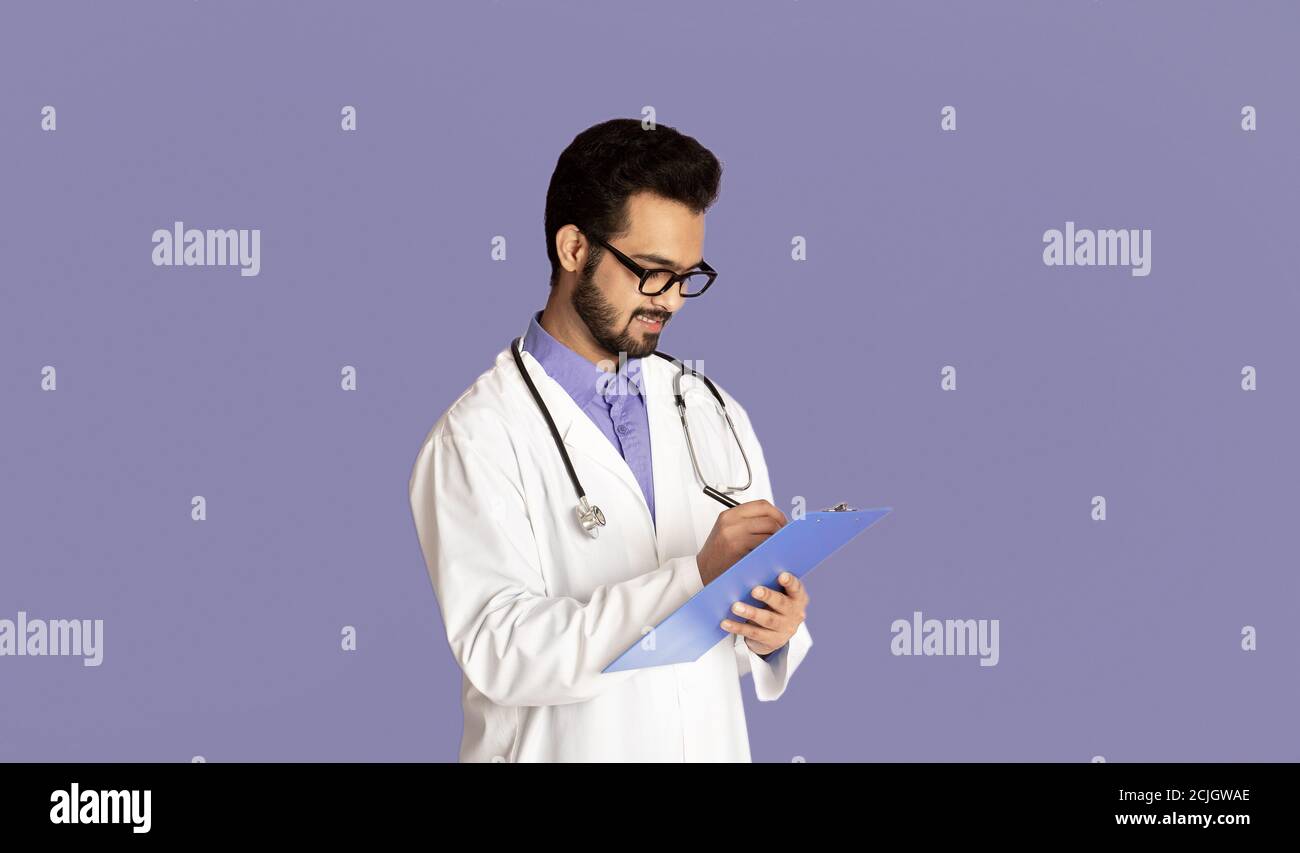 Indian doctor writing hi-res stock photography and images - Alamy