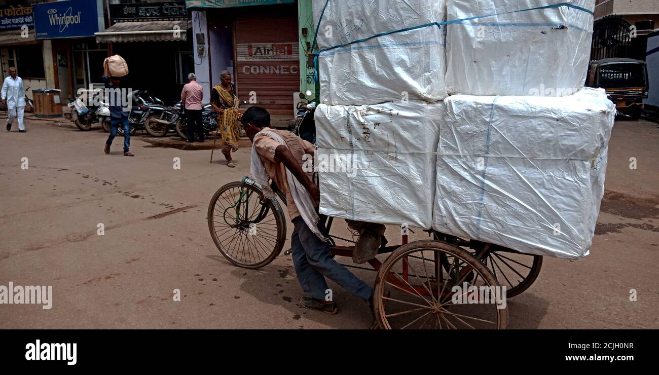 DISTRICT KATNI, INDIA - AUGUST 07, 2019: Indian rickshaw rider pulling ...