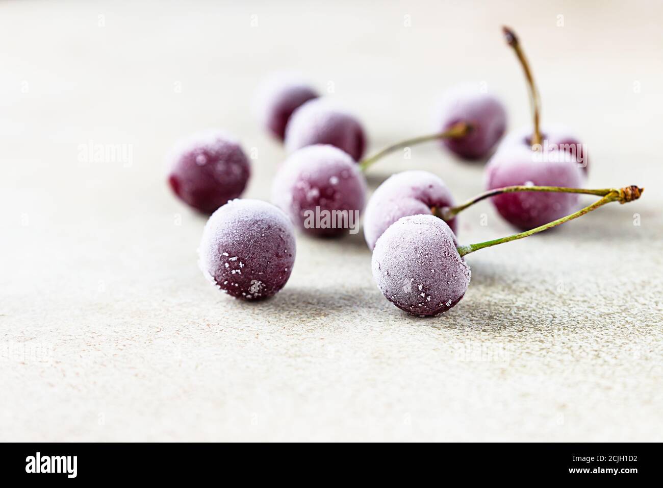 Frozen sweet black cherries covered with hoarfrost. Summer food. Useful ...
