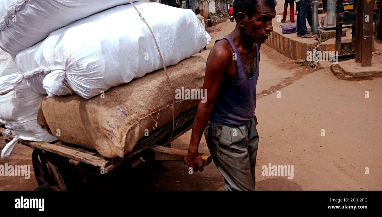 DISTRICT KATNI, INDIA - AUGUST 07, 2019: Indian worker transporting ...