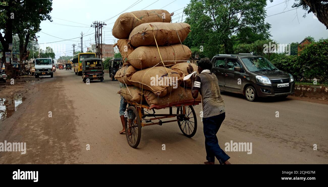 DISTRICT KATNI, INDIA - SEPTEMBER 05, 2019: An indian poor man pushing ...