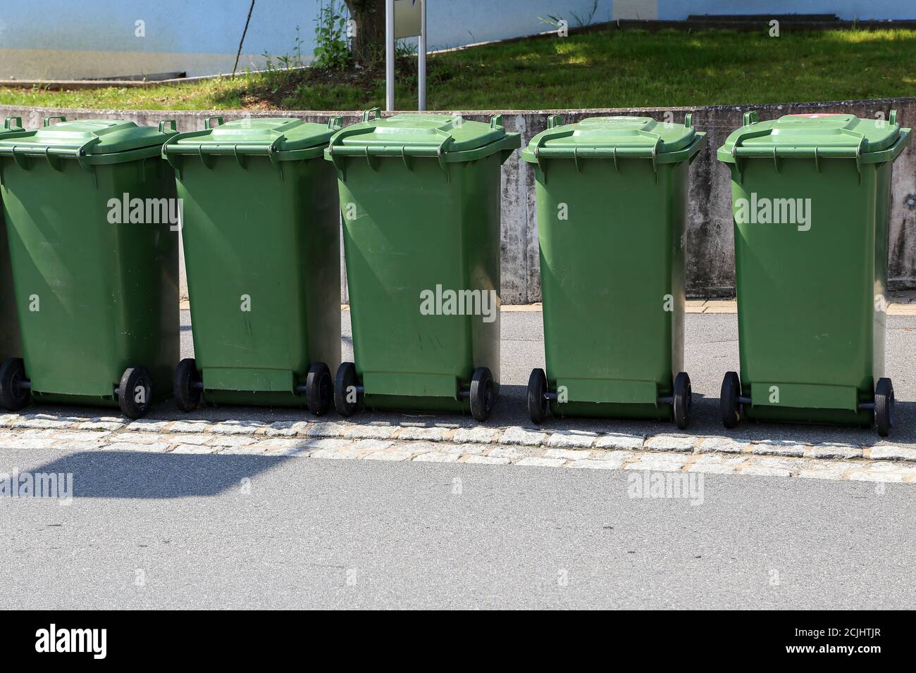 Lot of green garbage cans on the street Stock Photo - Alamy