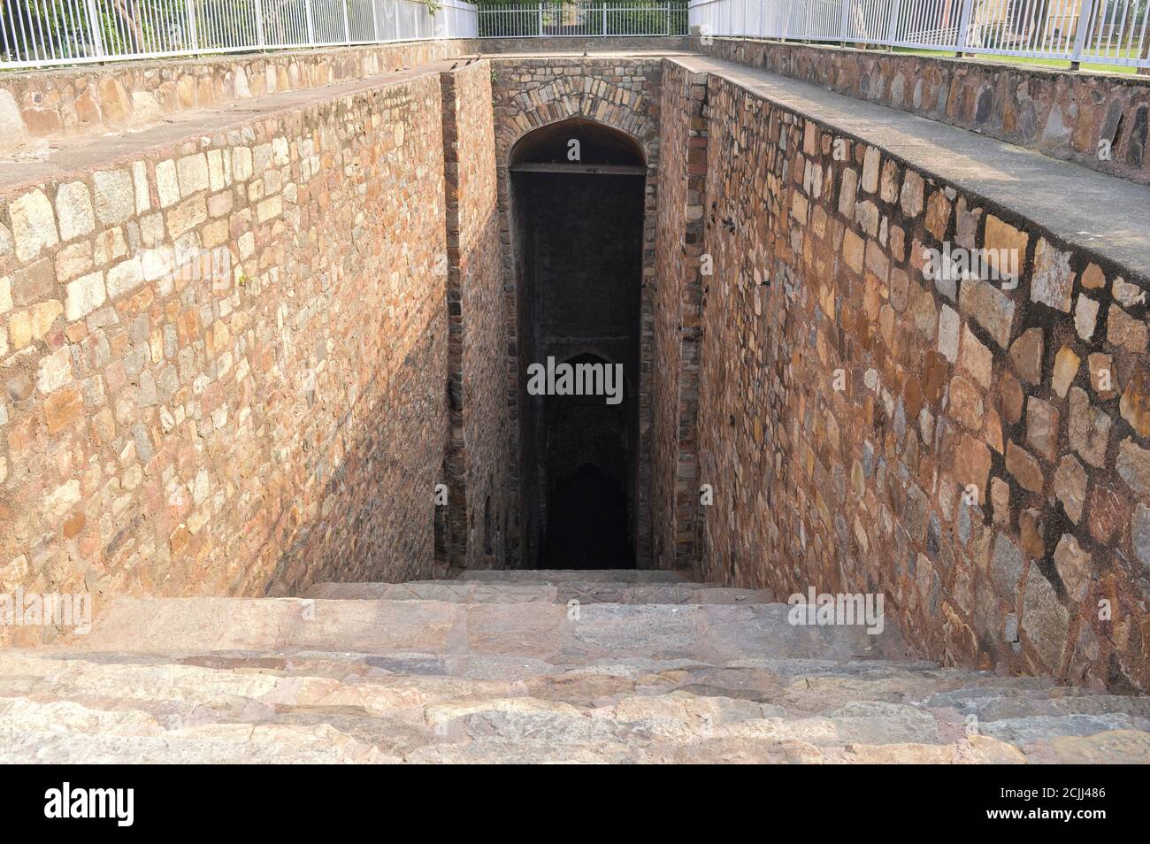 Step going down towards old well which is used for storage of water ...