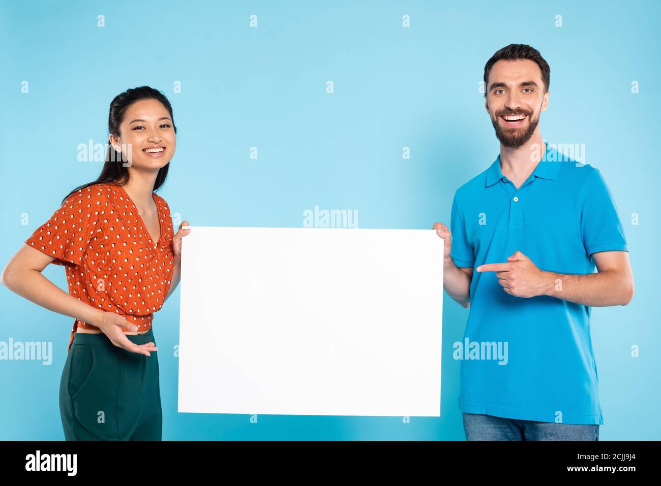 bearded man in polo t-shirt and asian woman in red dotted blouse ...