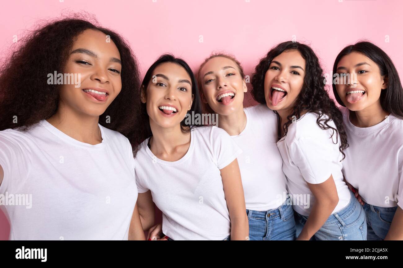 Multicultural Ladies Making Group Selfie Showing Tongues Over Pink ...