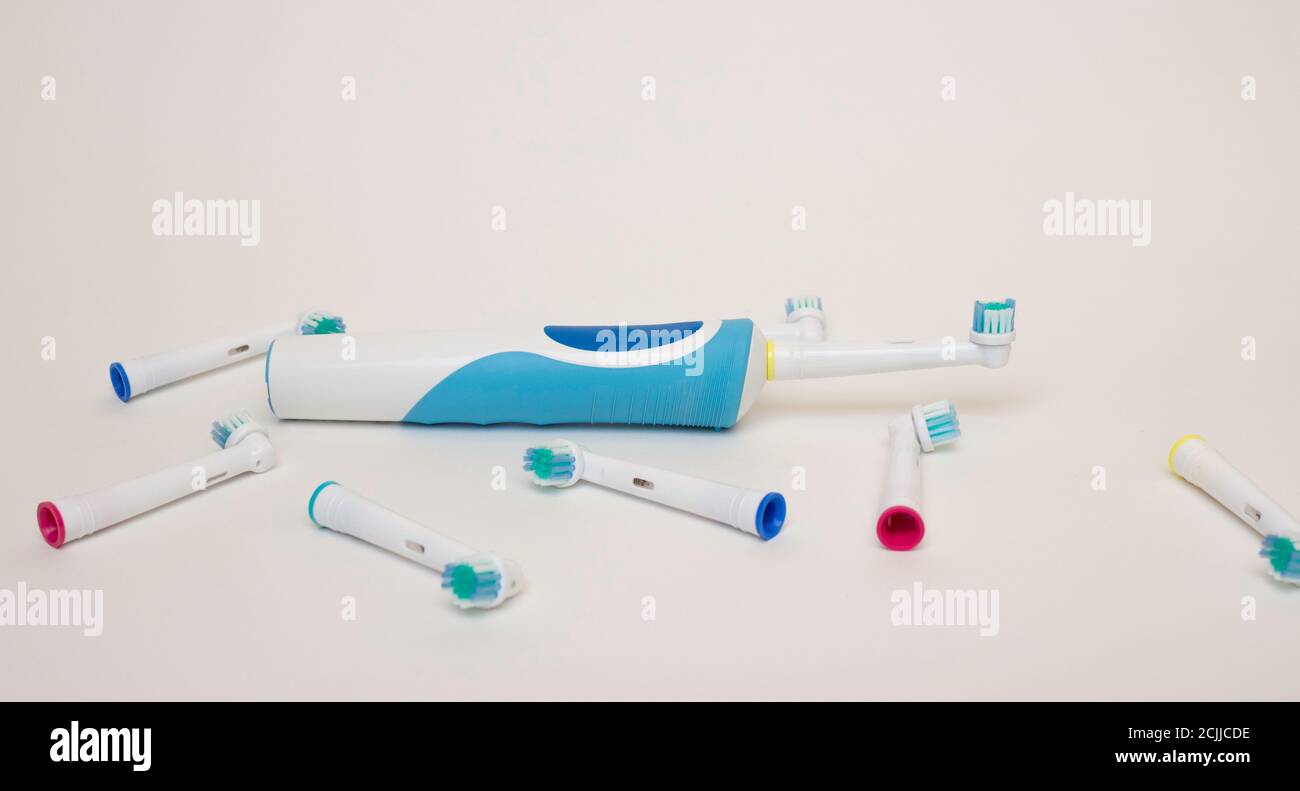 Electric toothbrush and removable parts from it on a white background ...