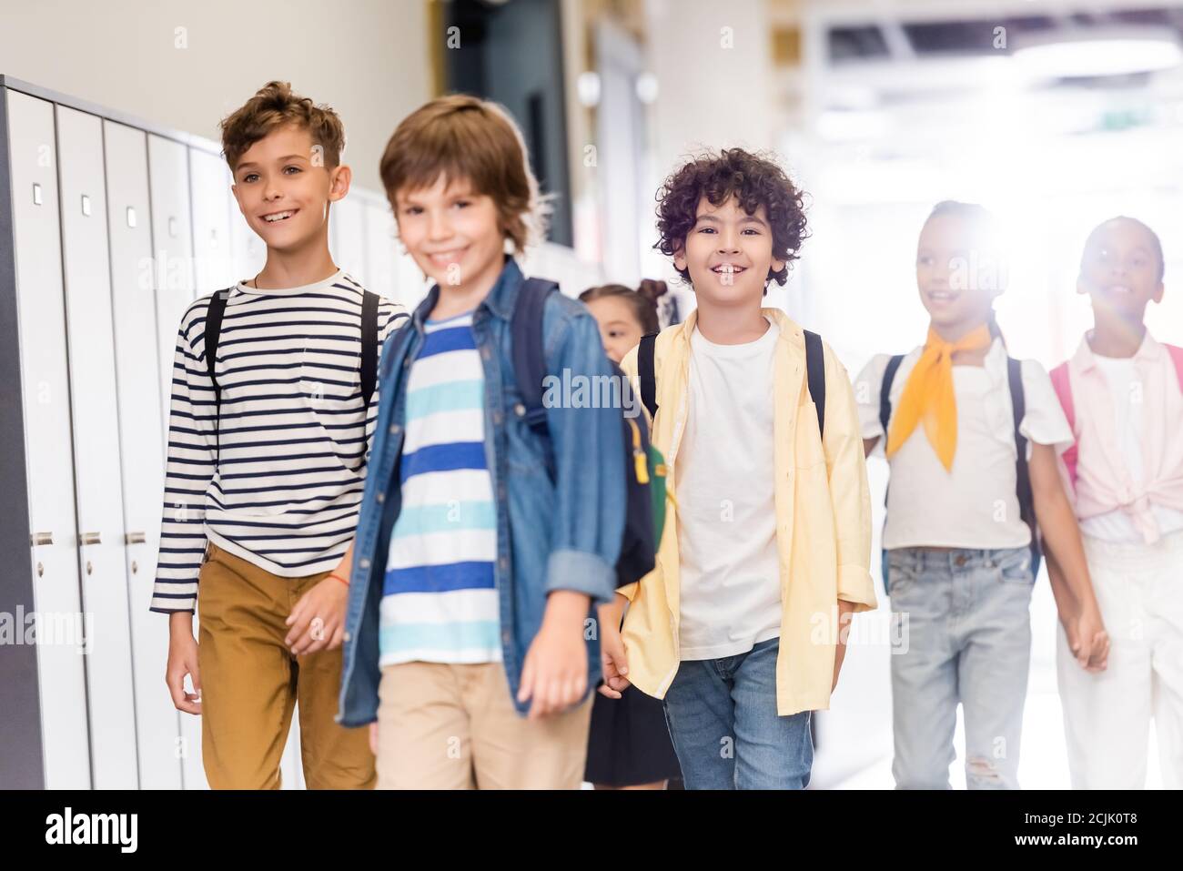 Children friends walking school backpacks hi-res stock photography and ...