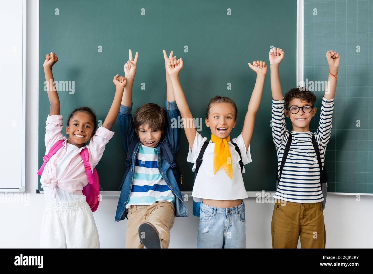 Selective focus of multicultural classmates showing peace and yes ...