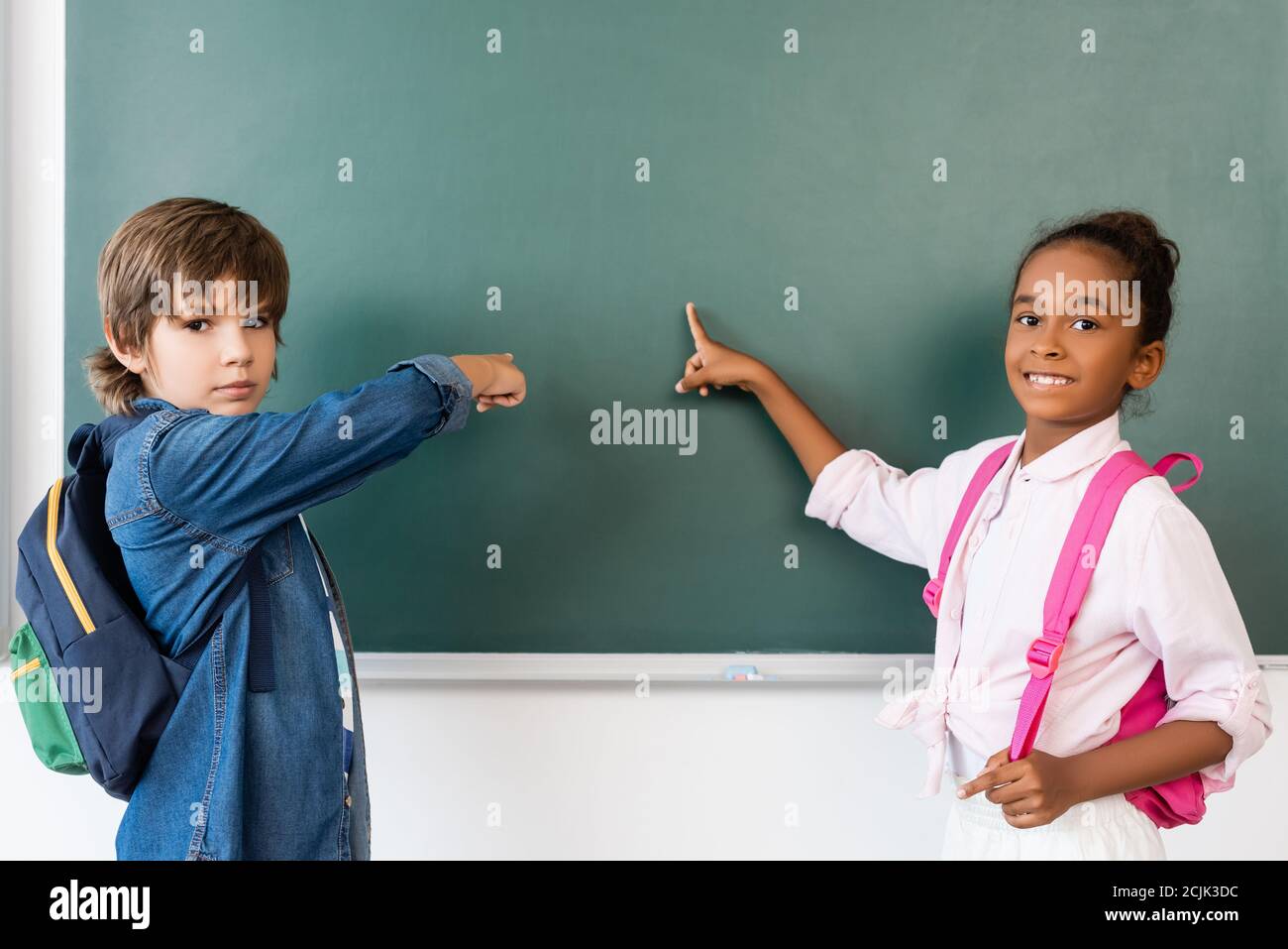 Happy children pointing together camera hi-res stock photography and ...