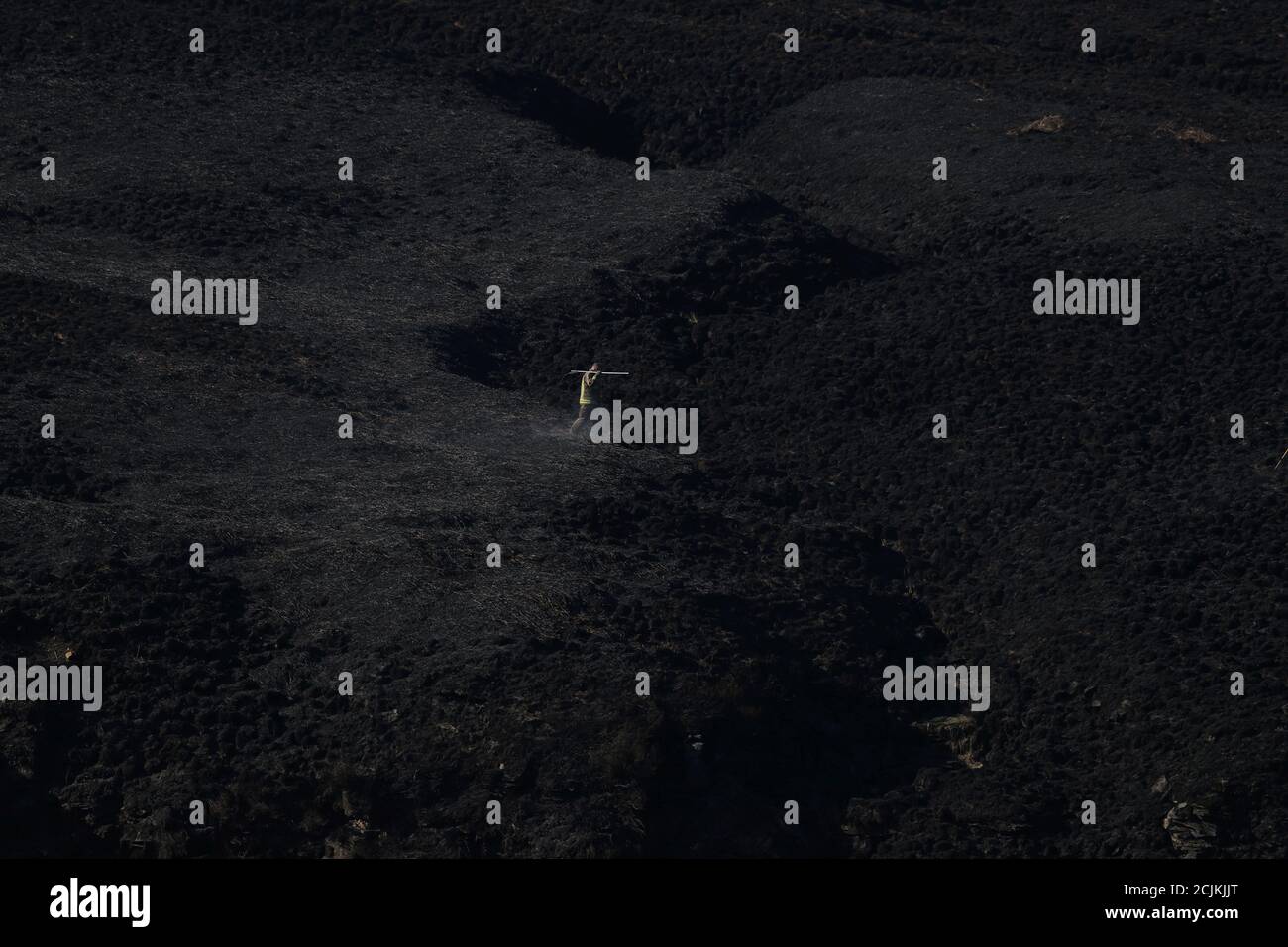 Fire service and National Trust personnel is seen after a fire on the ...