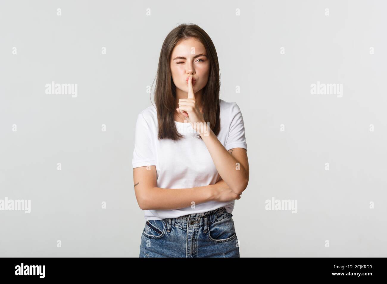 Sassy attractive brunette girl winking, shushing at camera, have secret ...