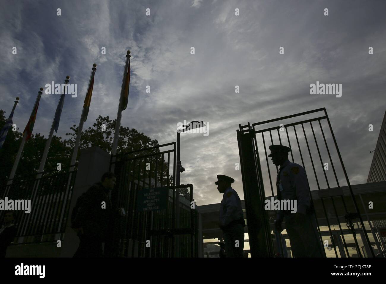 United Nations security guards are seen in silhouette during the 70th ...