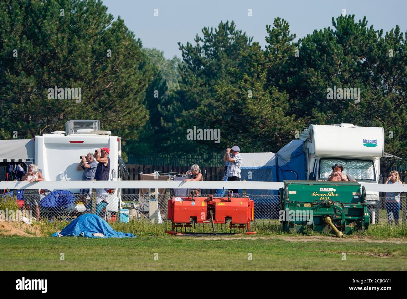 Campers in the caravan area in the centre of the course watch the ...