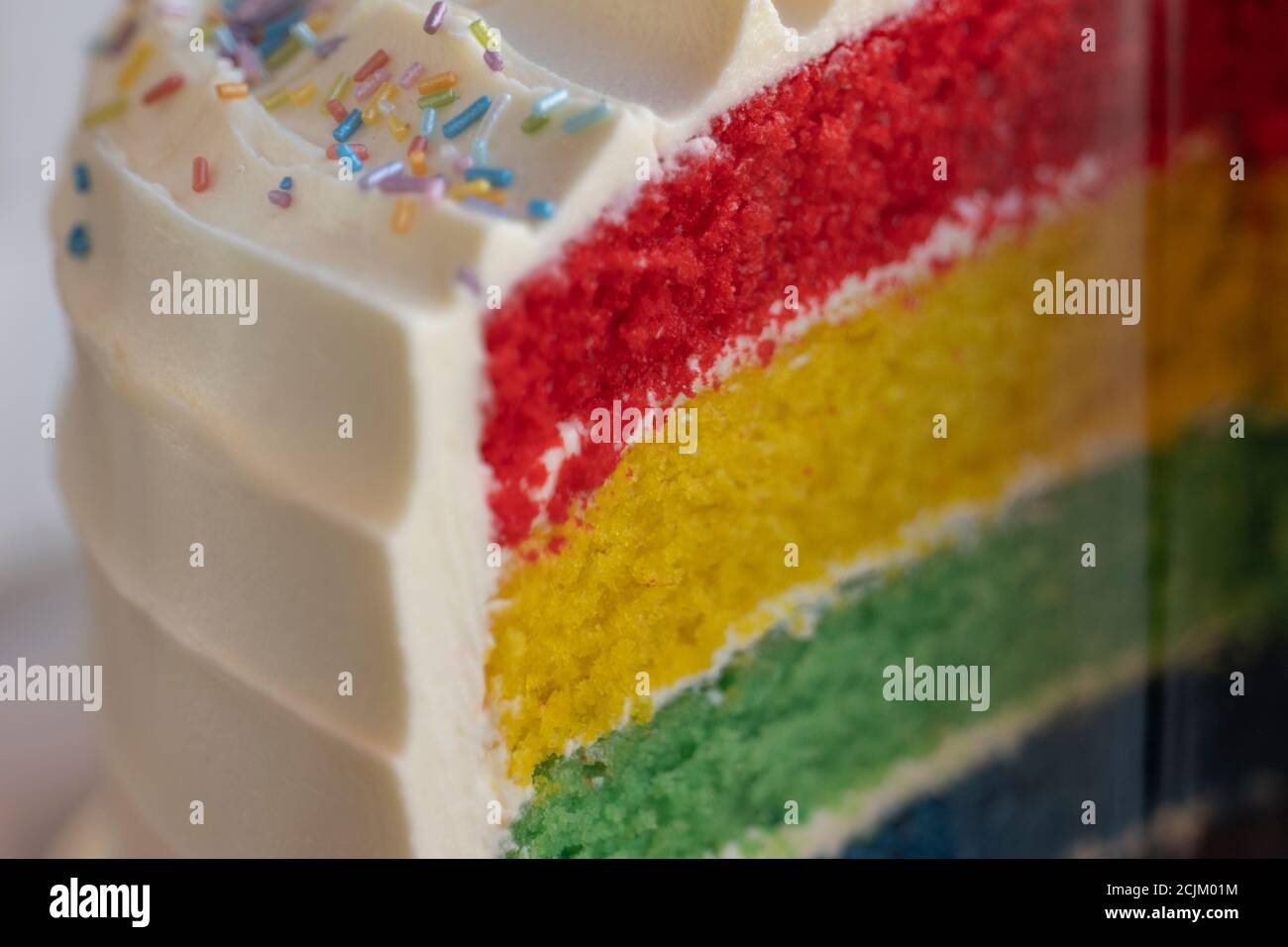 London, England. A brightly coloured rainbow cake in a coffee shop ...