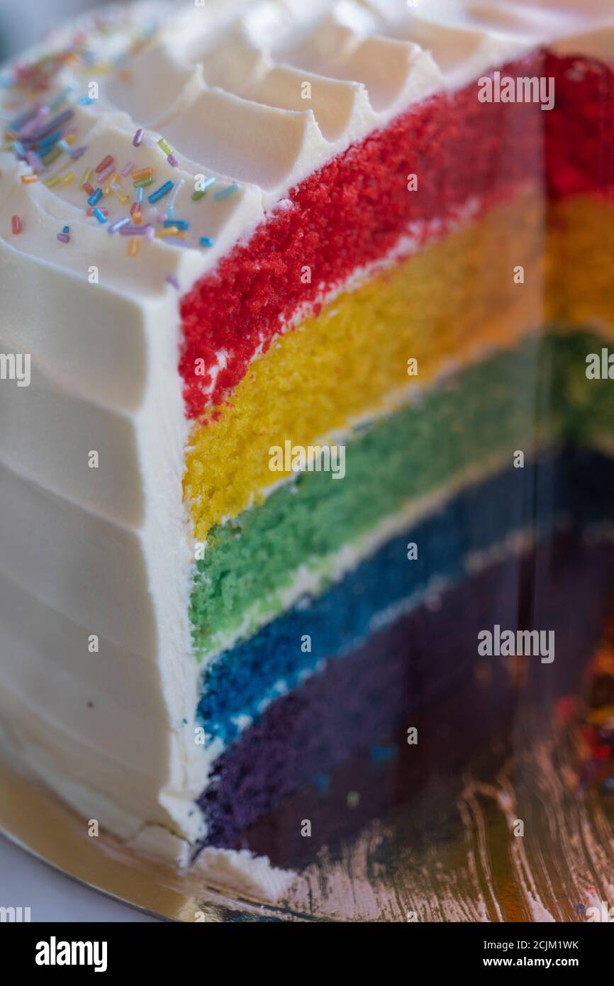 London, England. A brightly coloured rainbow cake in a coffee shop ...