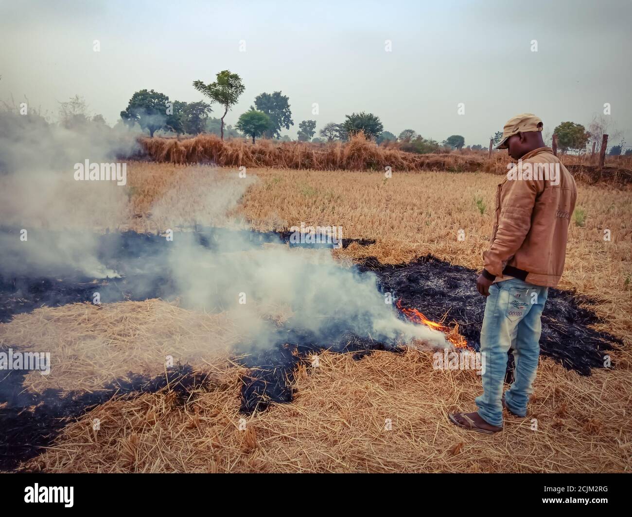 DISTRICT KATNI, INDIA - OCTOBER 06, 2019: An asian farmer burning fire ...
