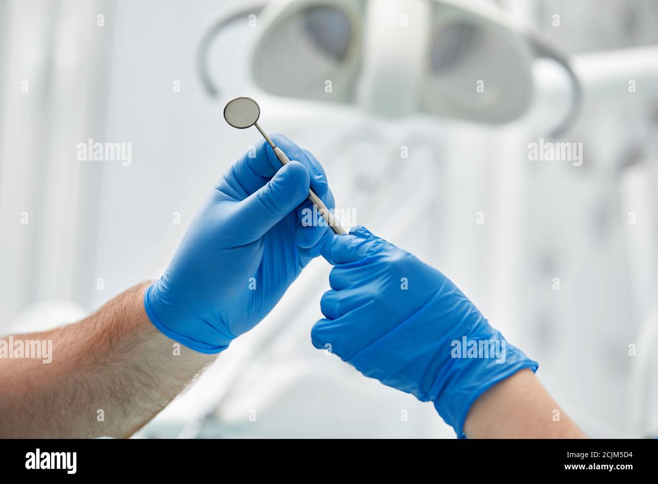Close-up of the hands of a dentist and nurse surgeon over an operating ...