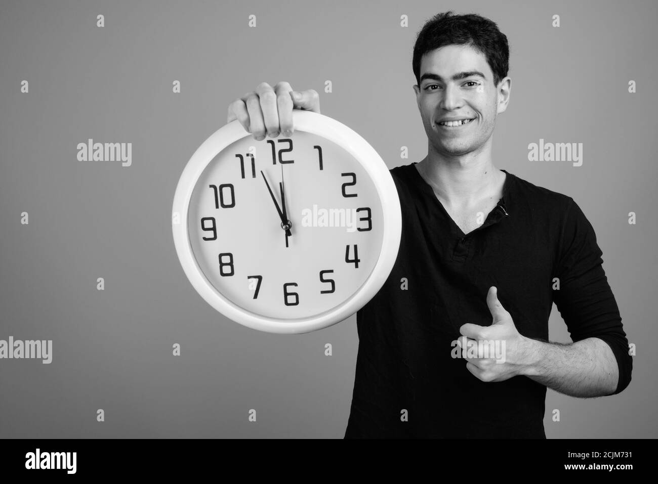 Man with clock hi-res stock photography and images - Alamy