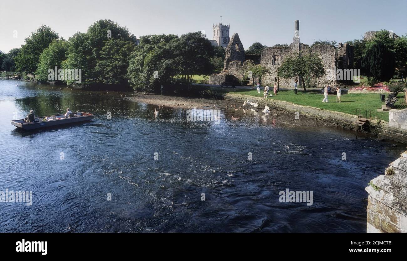 Anglers fishing from the Bridge Pool punt beside Christchurch Castle ...