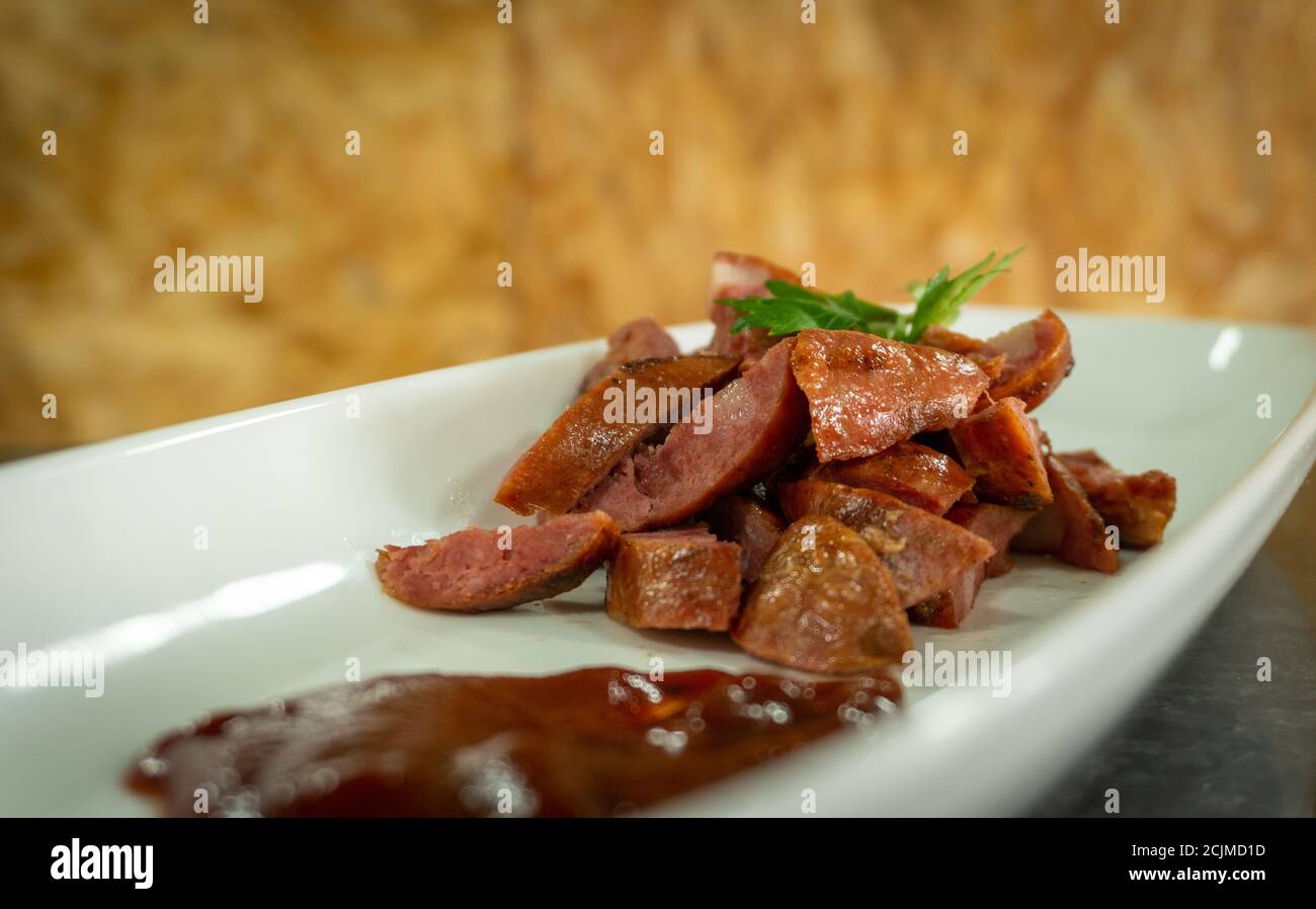 Closeup shot of sliced sausages with sauce Stock Photo - Alamy