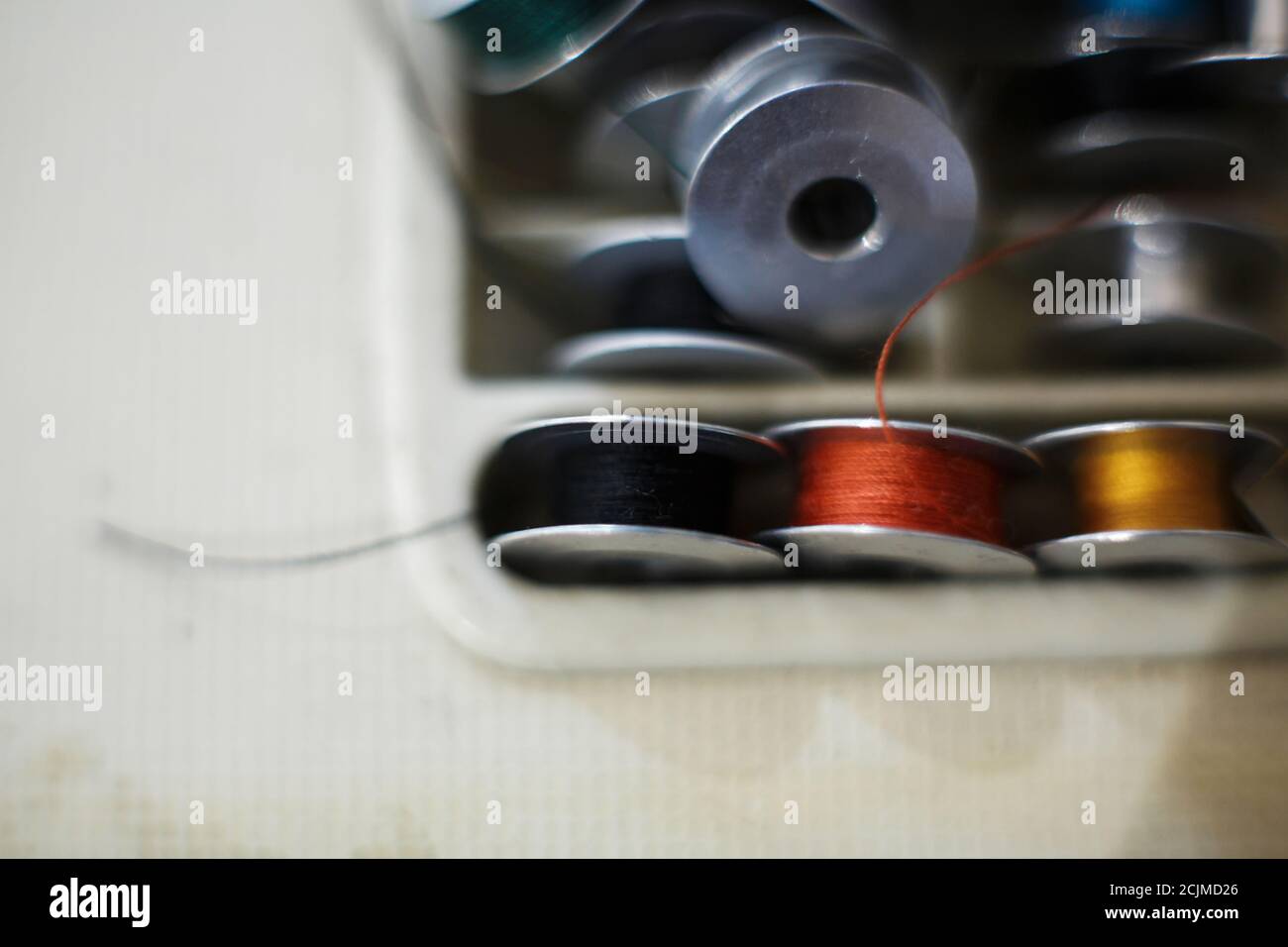 Closeup set of colored thread for a sewing machine. Workplace ...