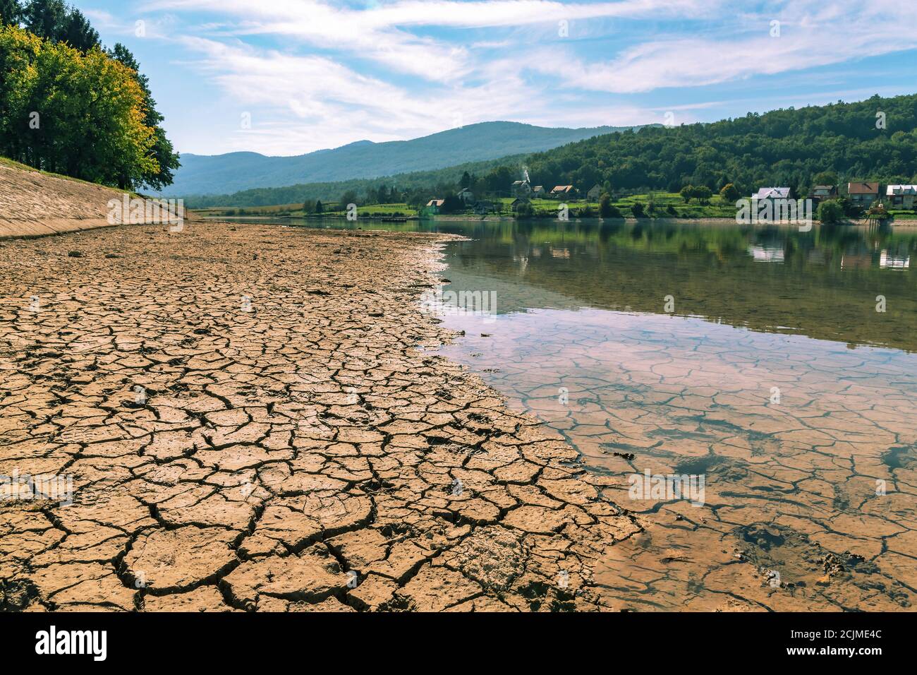 Dry cracked soil on the drying up watering place bank with animal ...