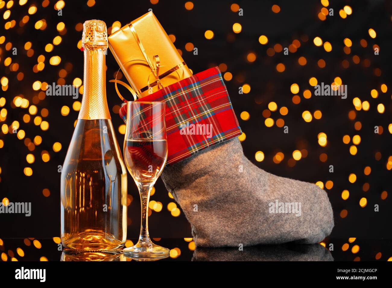 Champagne bottle and Christmas stocking with gifts Stock Photo - Alamy