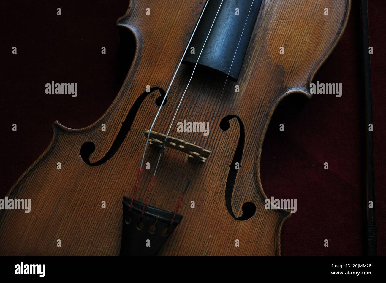 Beautifully designed old violin with missing strings set against a ...