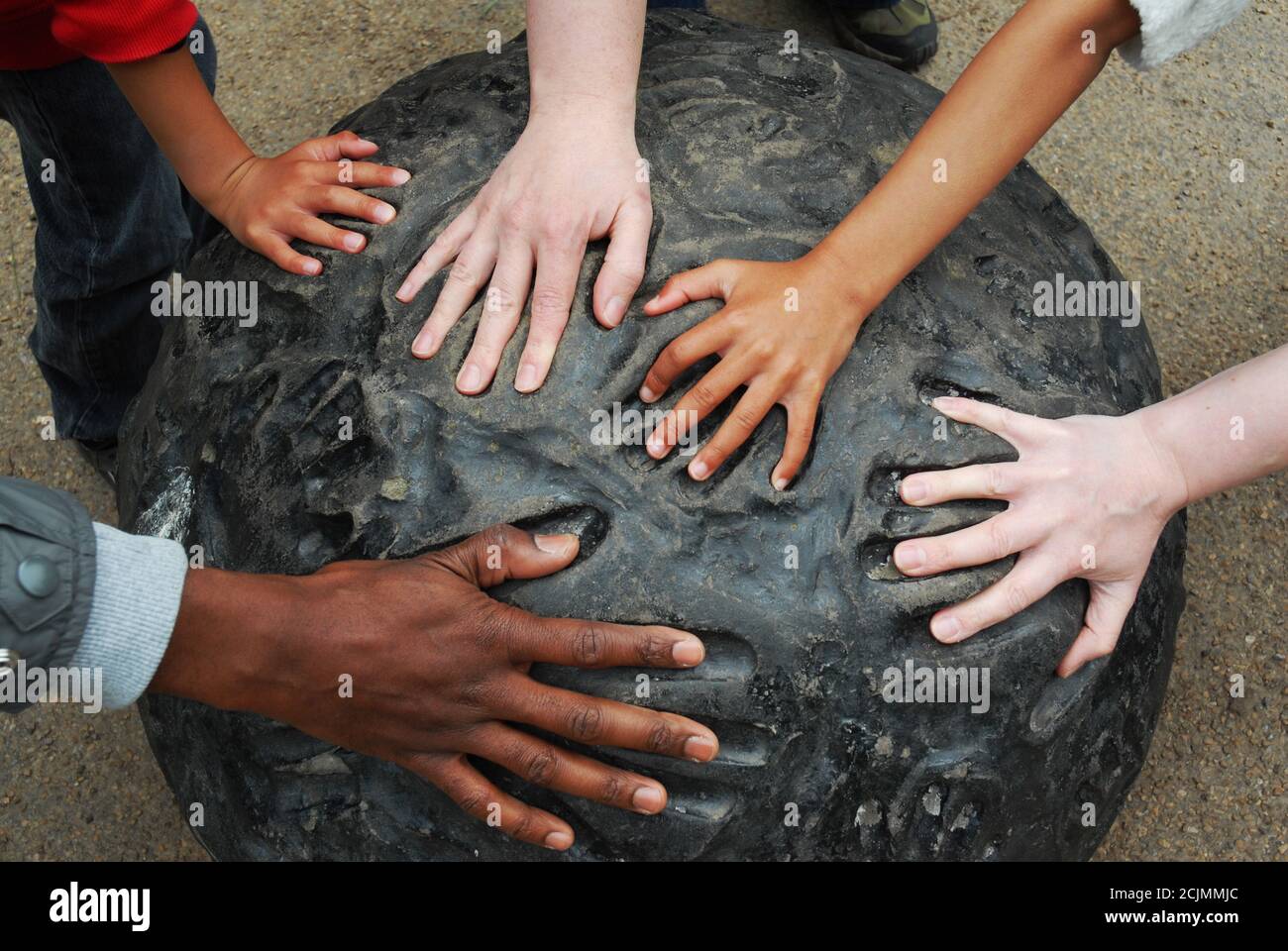 Multiple hands of different races fit into hand-prints on a piece of ...