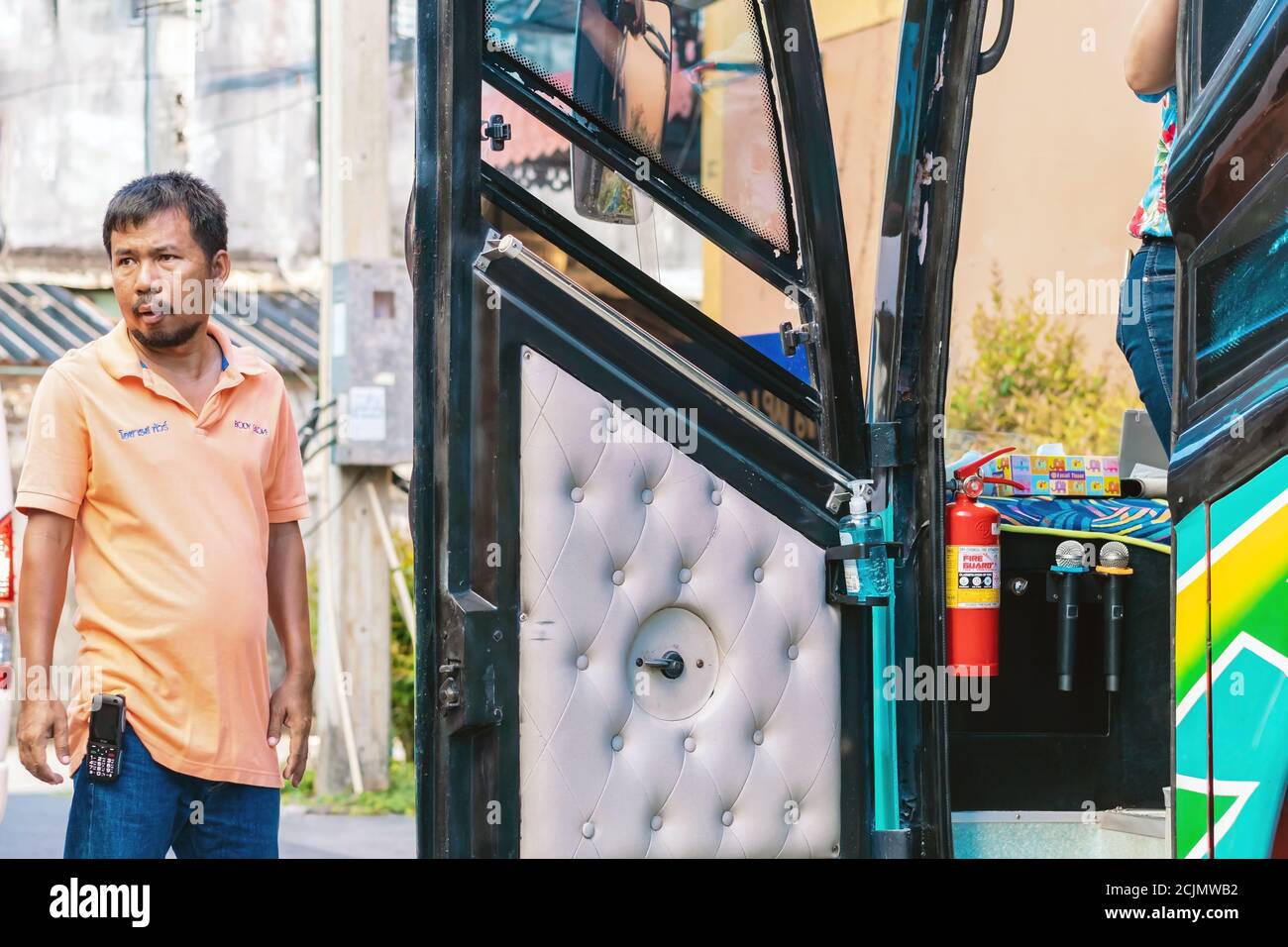 Man hanging off bus hi-res stock photography and images - Alamy