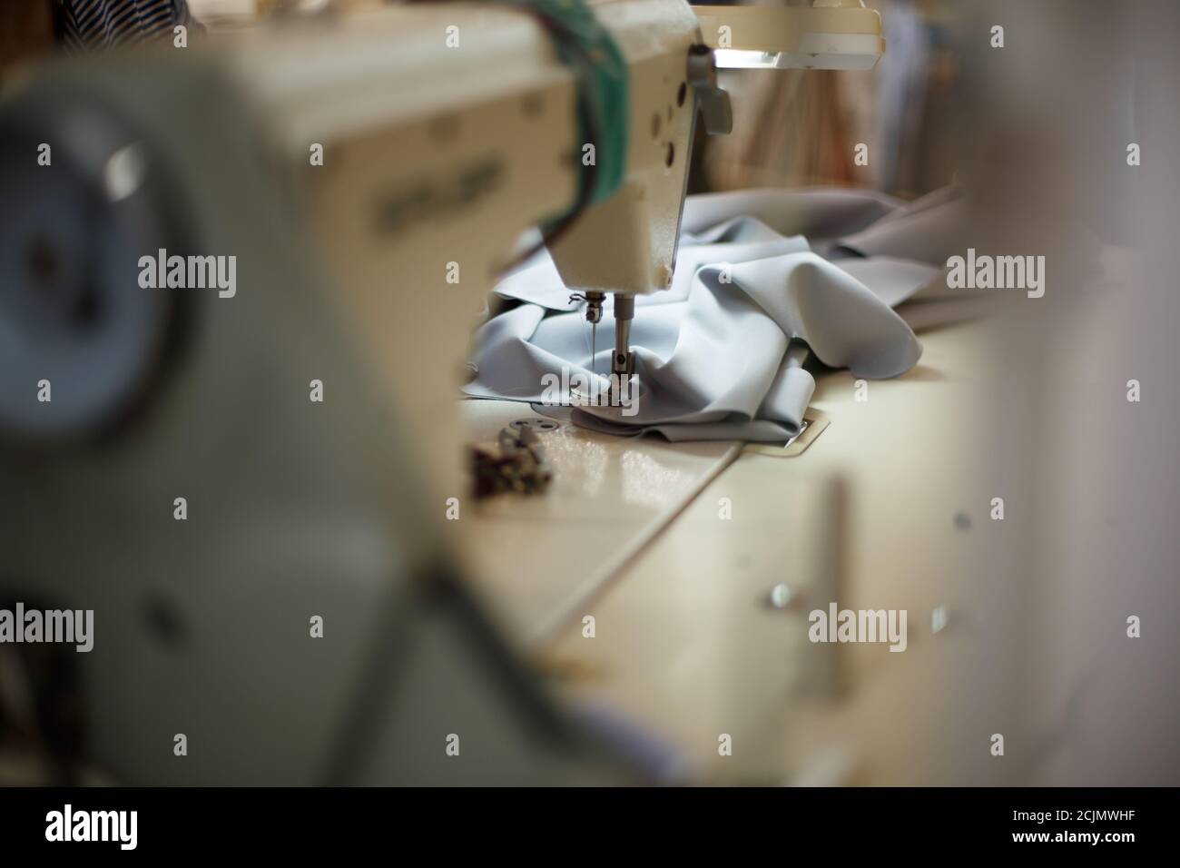 Close-up of a sewing machine with light on. workplace tailor. sewing ...
