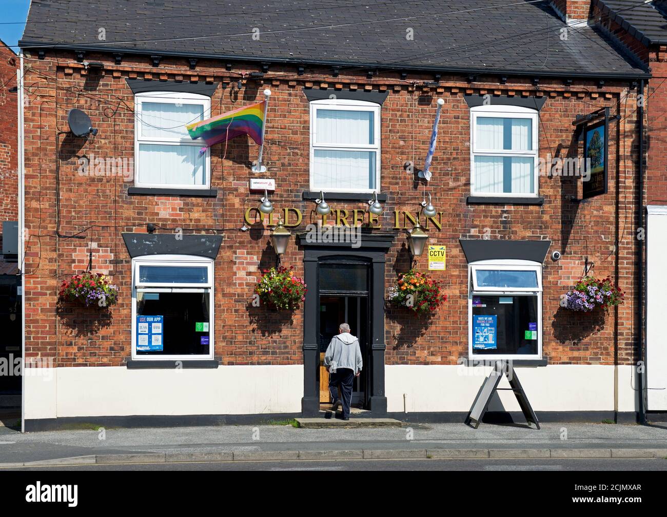 Man entering the Old Tree Inn, Kippax, West Yorkshire, England UK Stock ...
