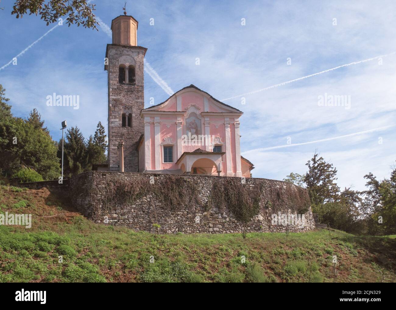 a brightly colored country church on top of a hill on a sunny day ...