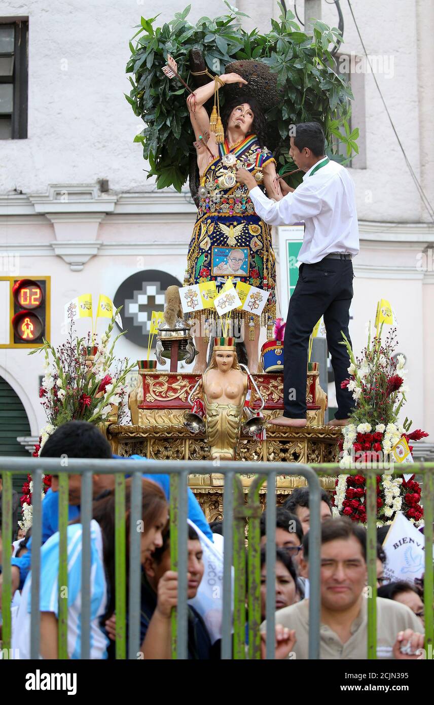 A man from Cusco decorates a statue of Saint Sebastian before Pope ...
