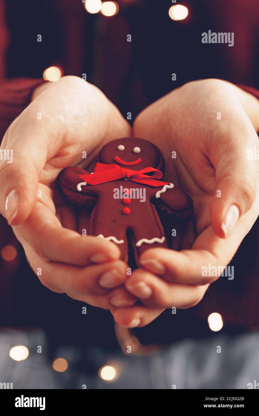 Female hands holding gingerbread man close up Stock Photo - Alamy