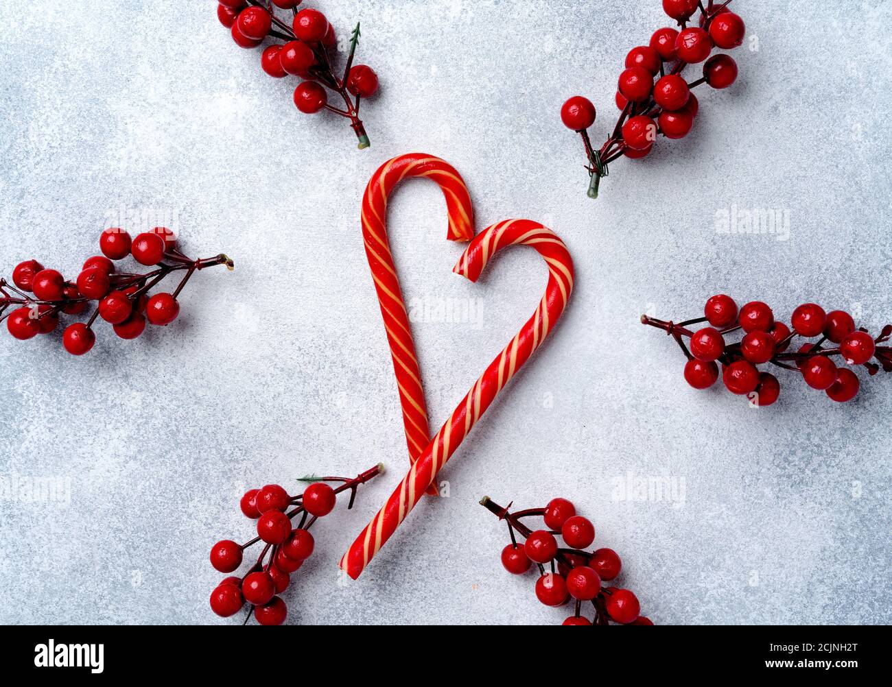 Candy canes on grey frosted background top view Stock Photo - Alamy