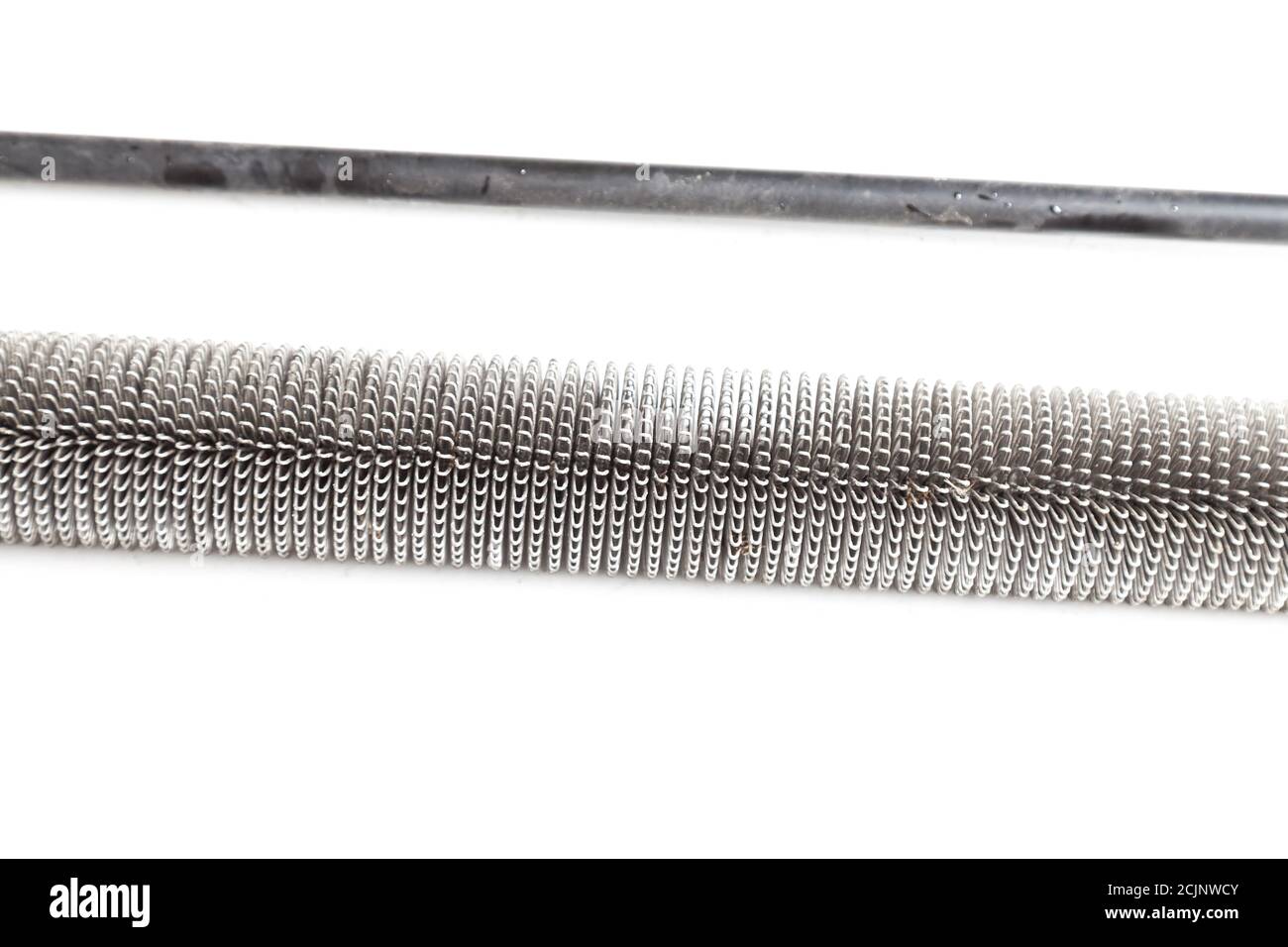 Close-up of a tube of an aluminum radiator with twisted coils on a ...