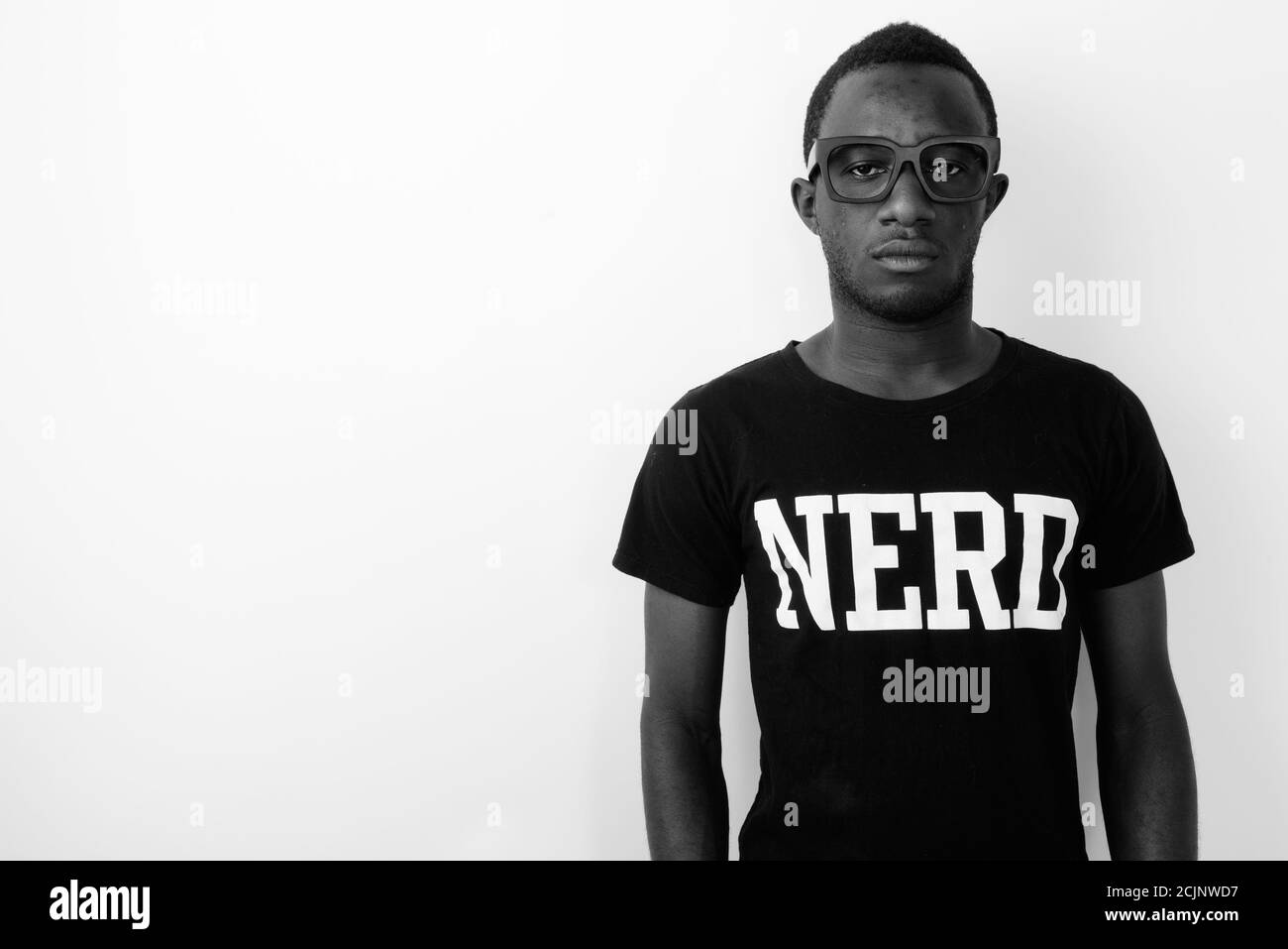 Studio shot of young black African geek man wearing Nerd shirt against ...