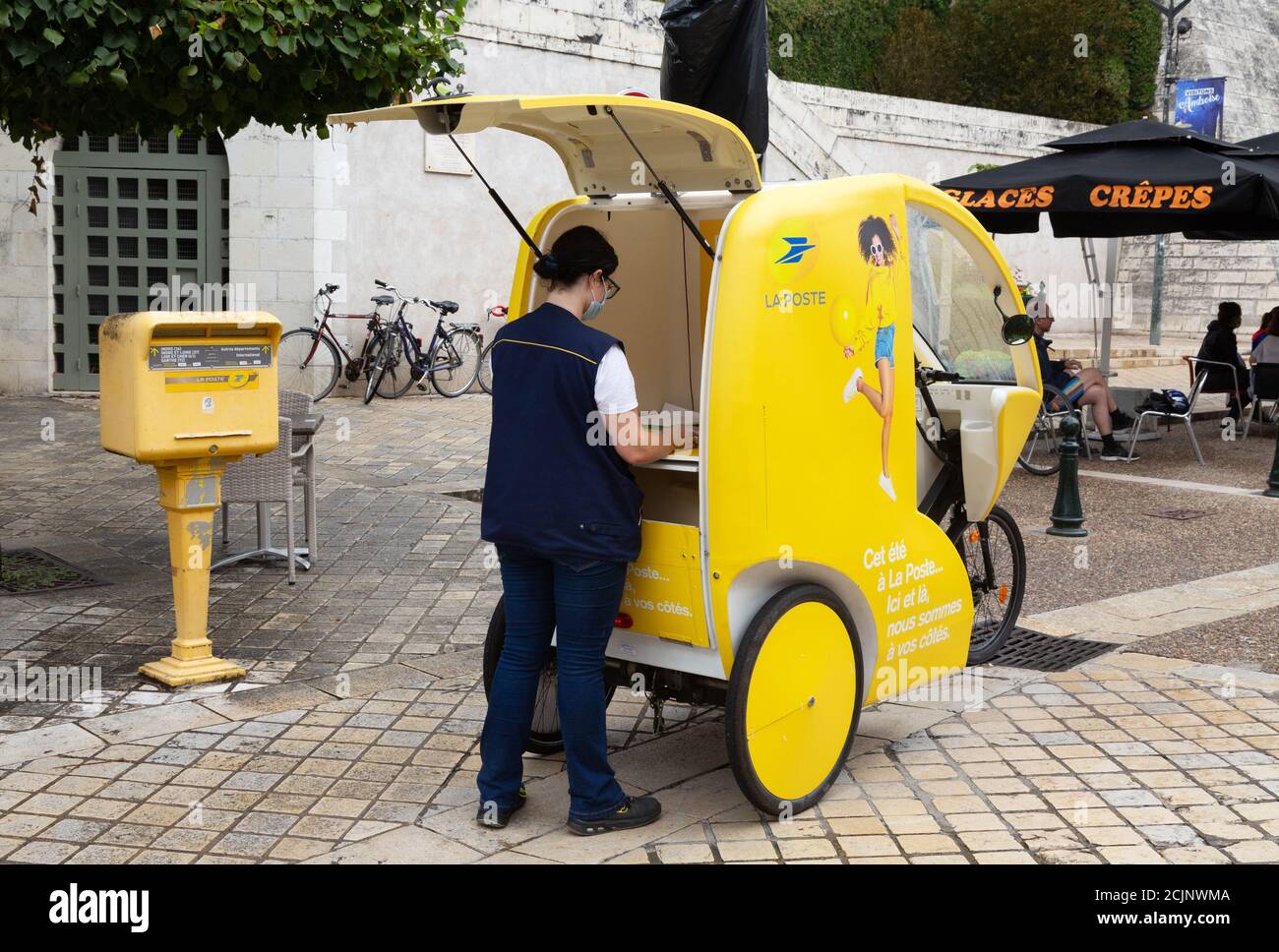 La Poste France, a French Postal Company - a woman postman collecting ...