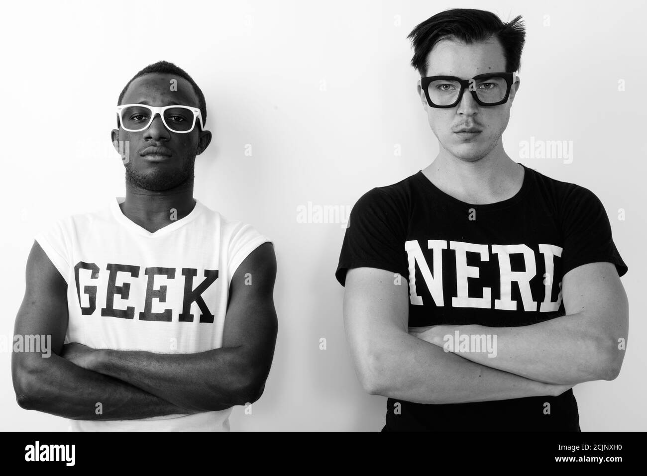 Studio shot of young black African Geek man with European Nerd man ...