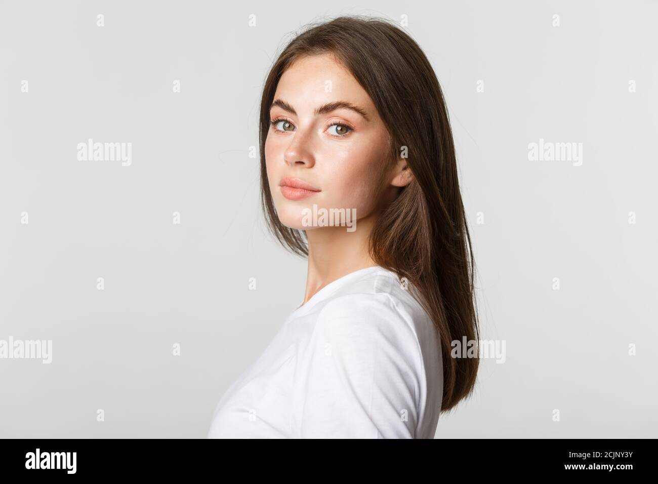 Portrait of confident beautiful brunette woman turning face at camera ...
