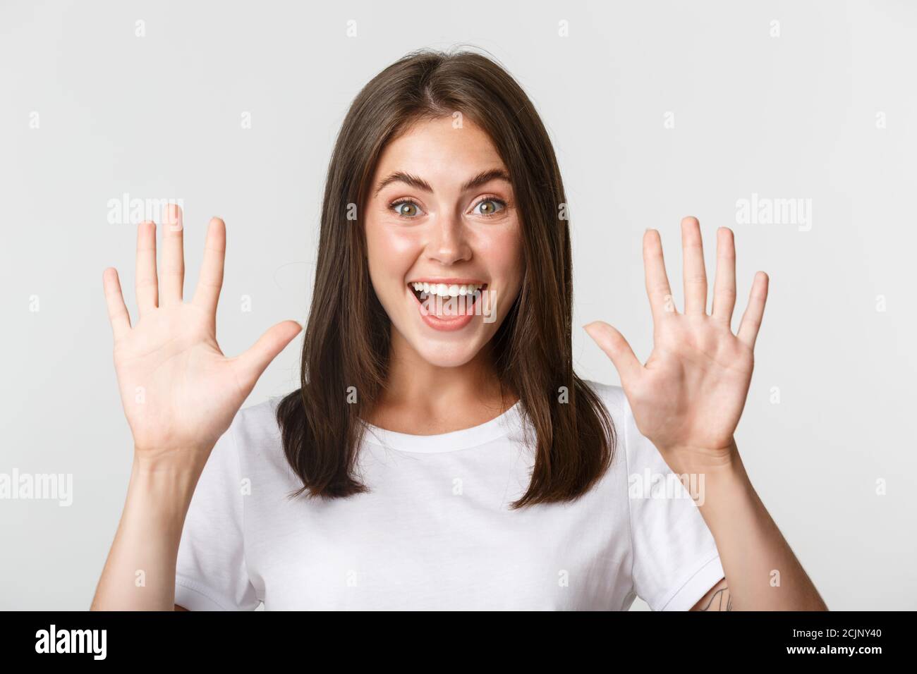 Close-up of cheerful attractive young woman smiling, showing ten ...