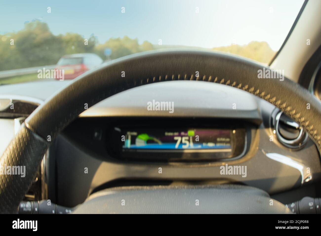 An electric car speedometer whilst on motorway Stock Photo - Alamy