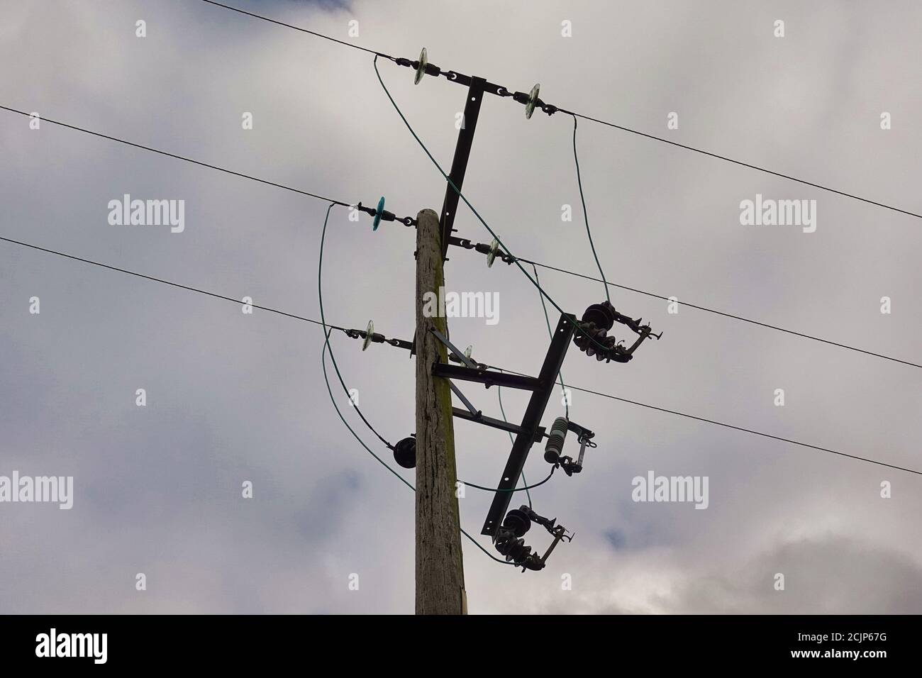 3 cable power wires on wooden pole in the UK countryside Stock Photo ...