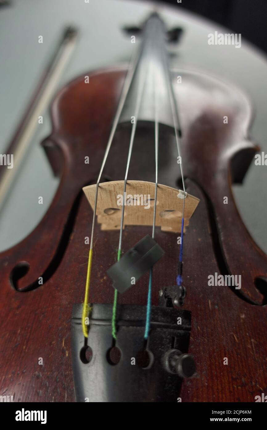 A fiddle and bow musical instrument showing bridge and fingerboard ...