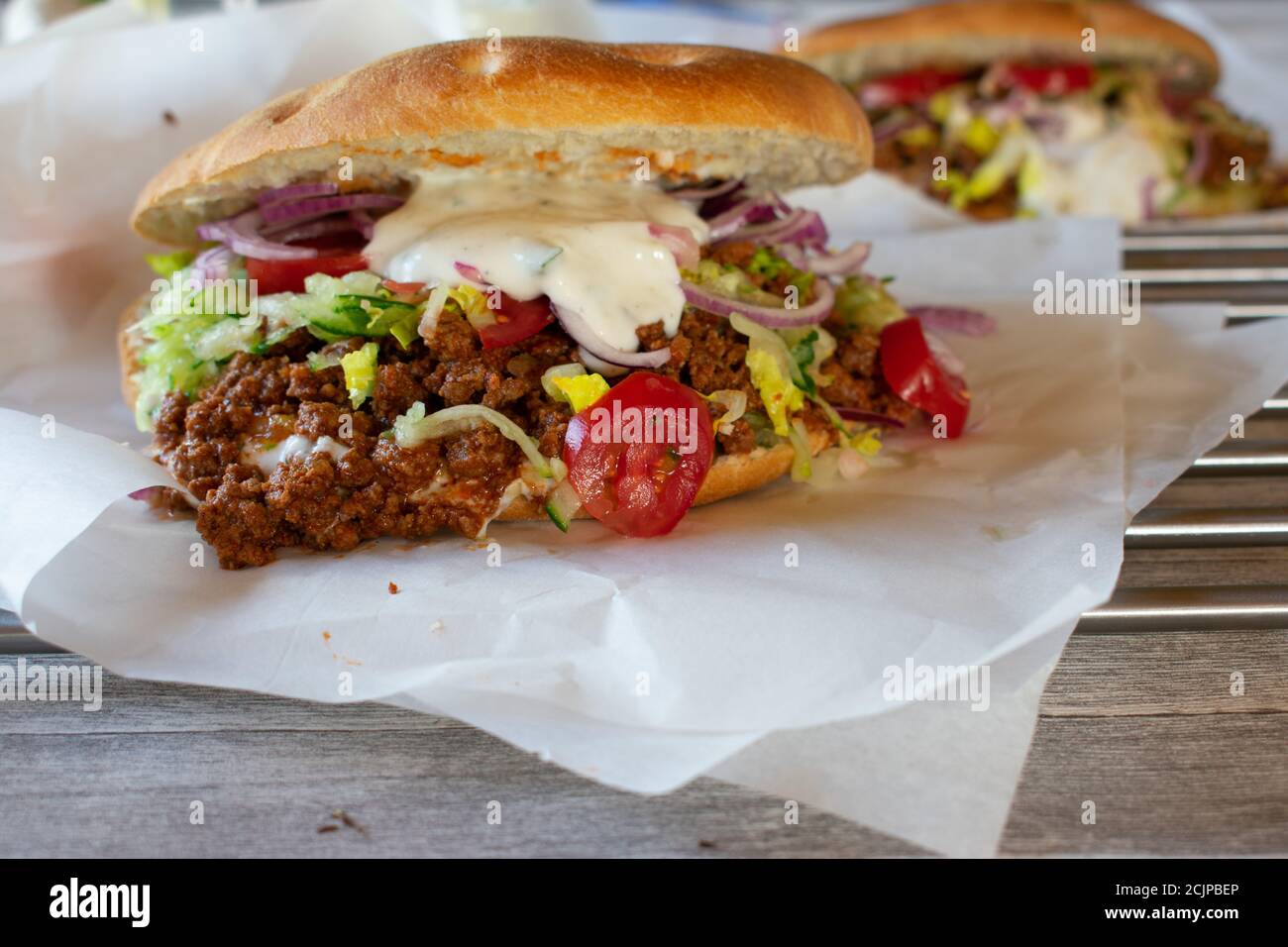 Flatbread with kebab meat and vegetables and sauce Stock Photo - Alamy