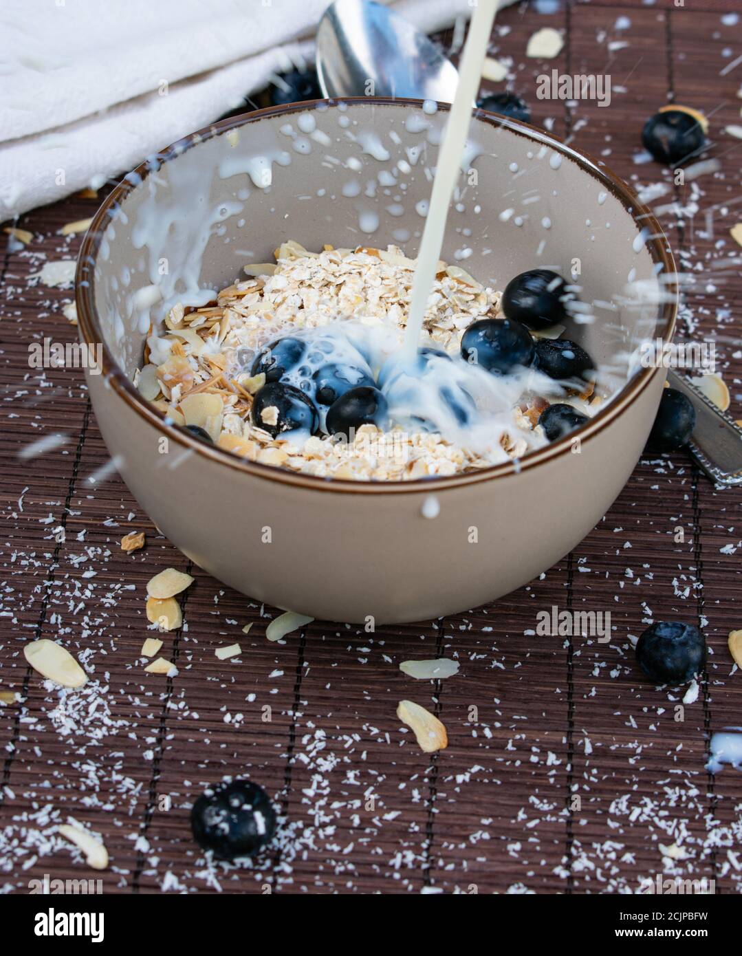 oatmeal milk splash on dark background Stock Photo - Alamy