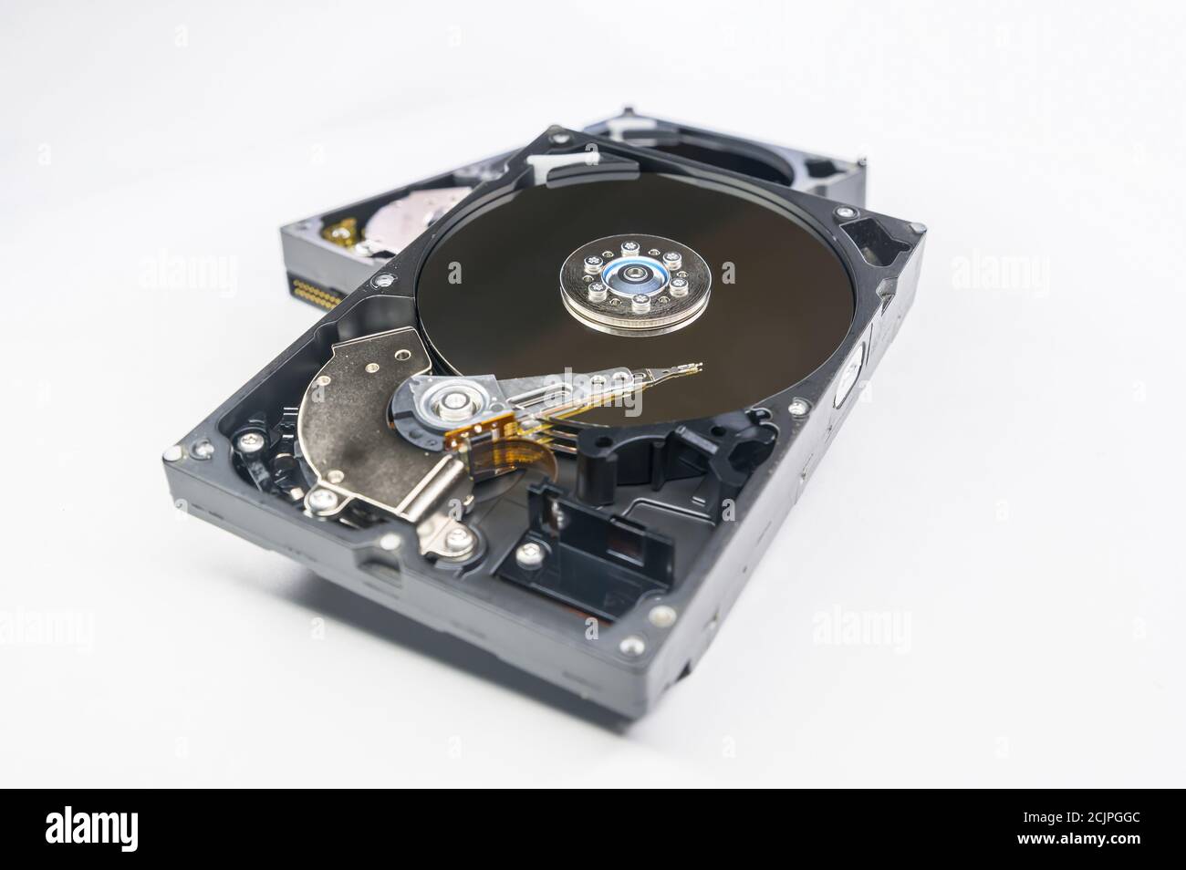 Old-fashioned, open, mechanical harddisc drive, isolated on a white ...
