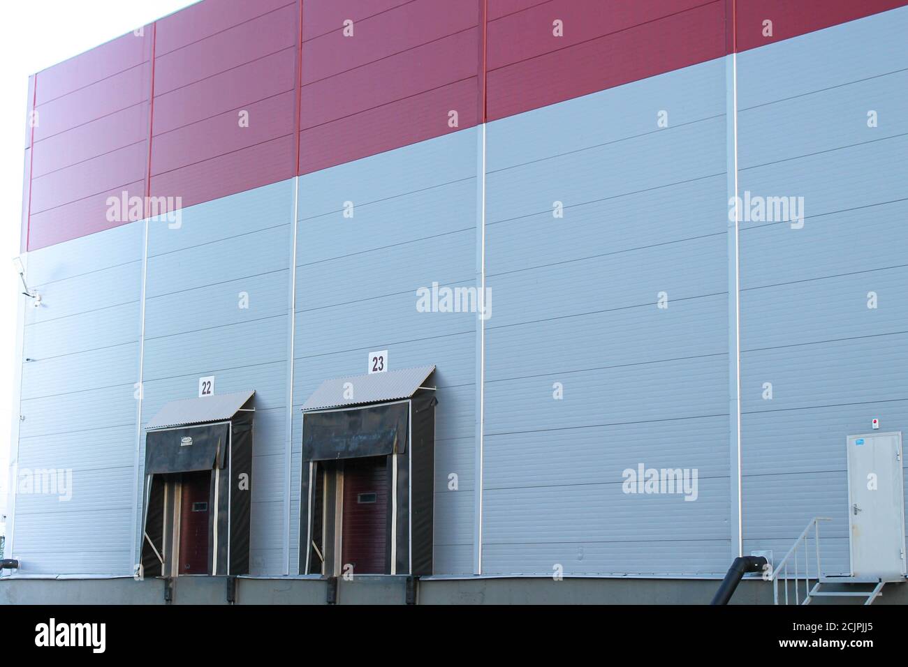 Warehouse complex outside with a gate for loading goods into the car ...